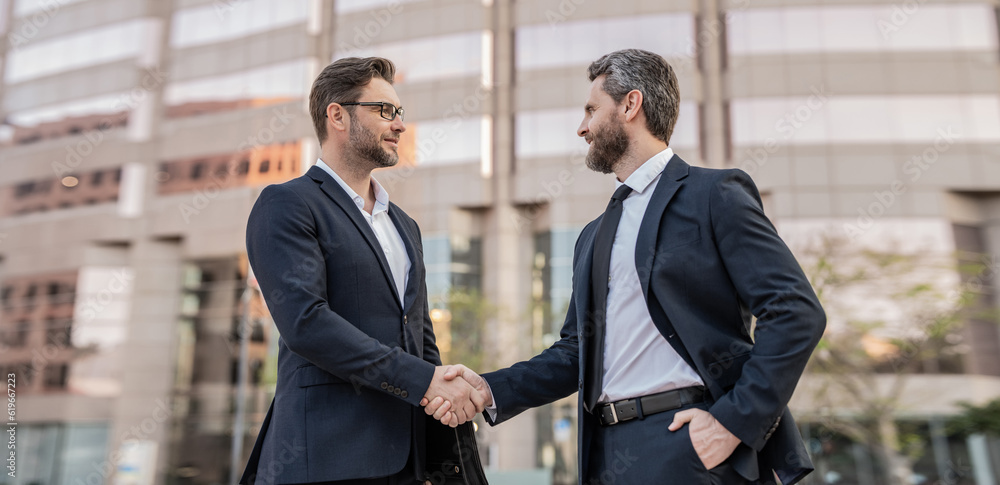 happy two businessmen in suit deal with handshake. photo of two ...