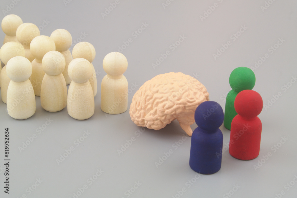 Colored people figures with human brain and ordinary wooden figures in ...