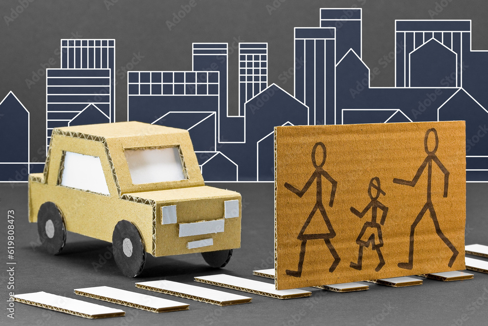 Black and white pedestrian crossing with cardboard stopped car and ...
