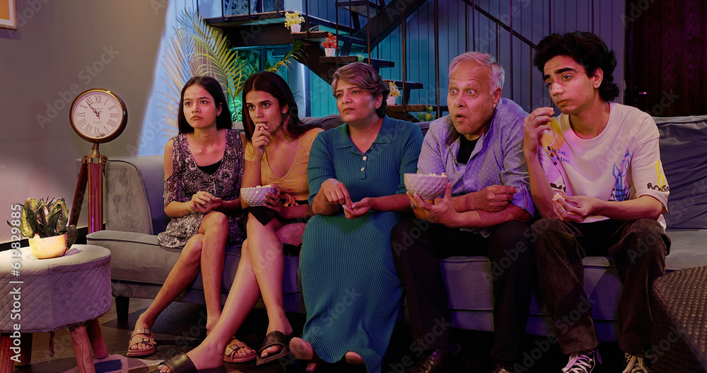 Scary Indian Asian family friends sitting sofa couch watch horror TV ...