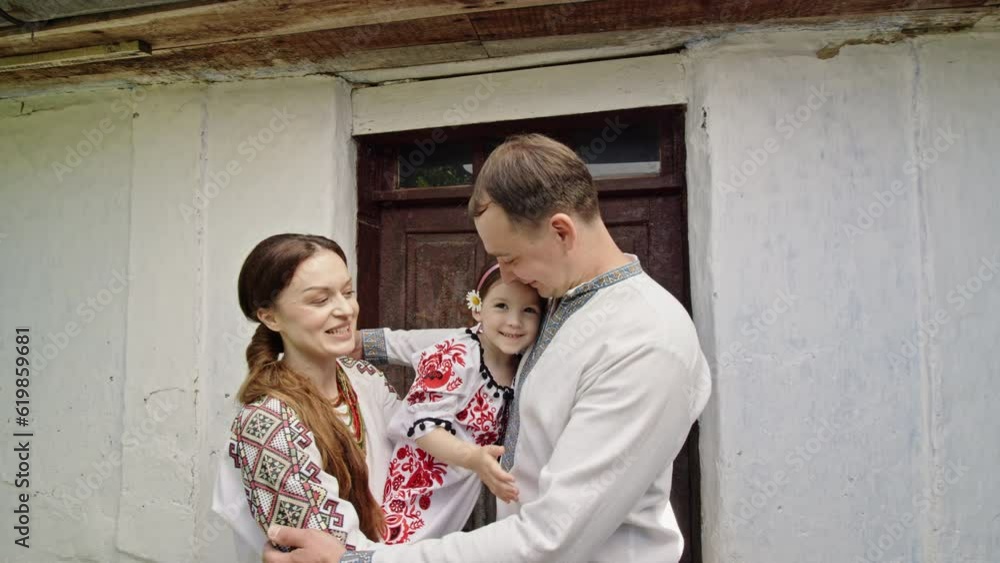 Happy Ukrainian family in traditional clothes hugging near house Stock ...
