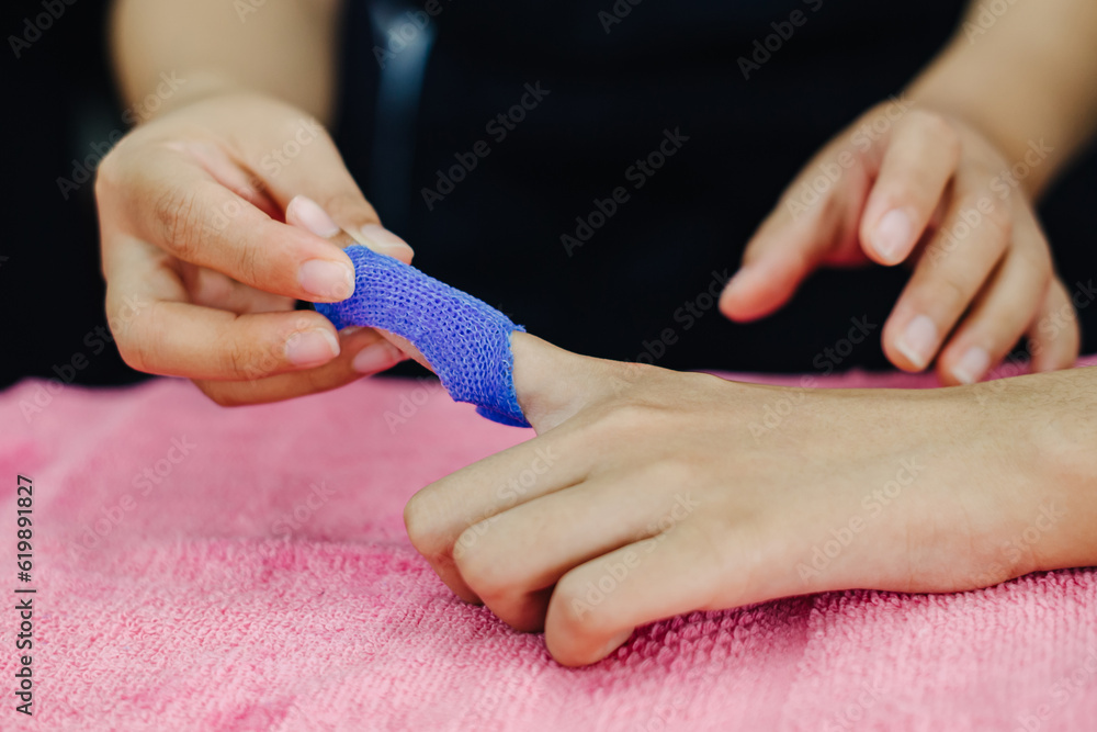 Therapist making asissistive device for immobilize patient finger from ...
