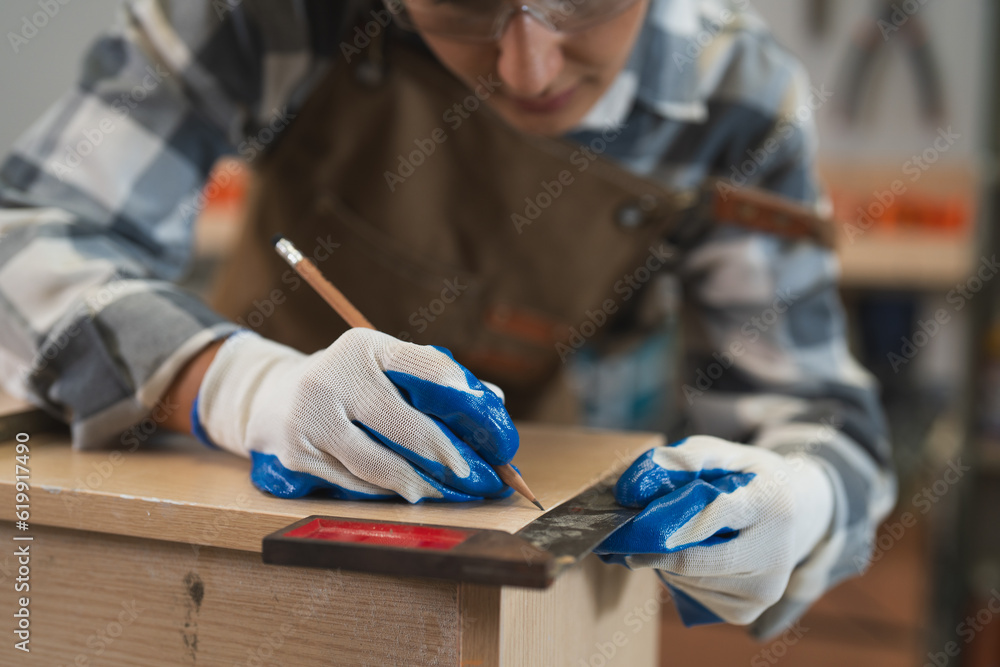 Female carpenter hands wear gloves using square ruler tool measuring ...