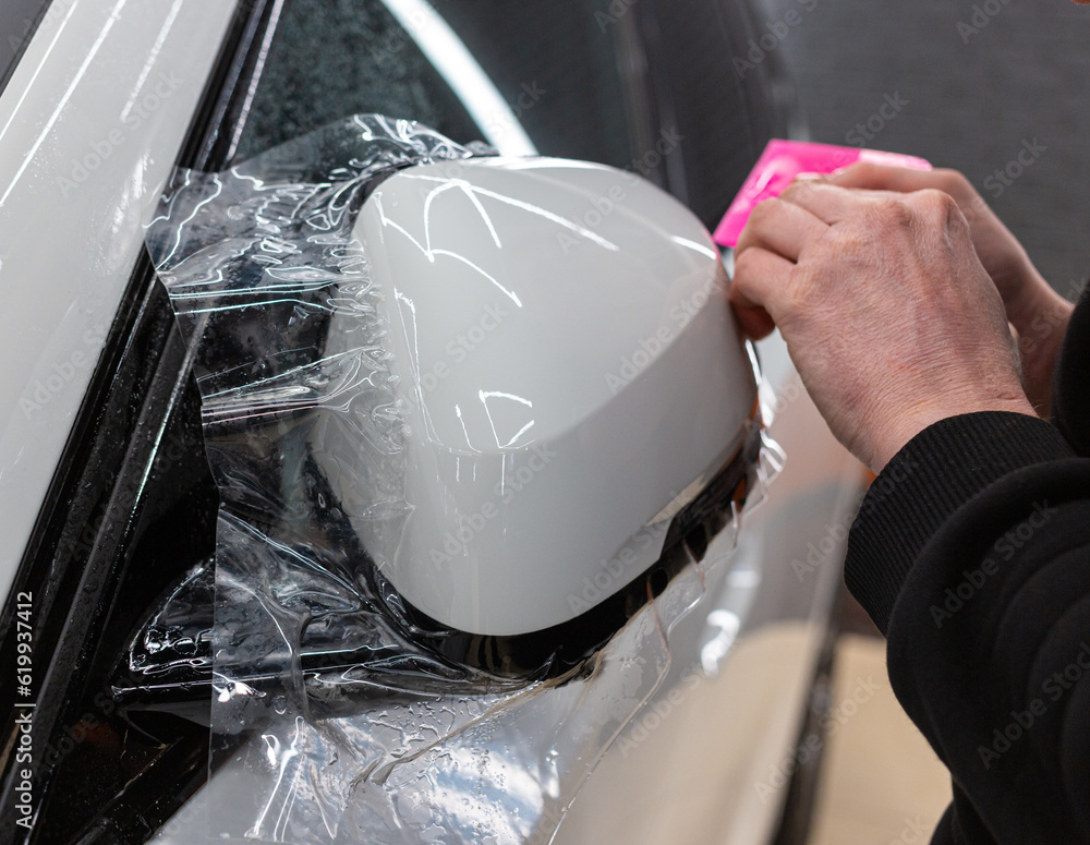 The process of installing PPF on the side of the car. PPF is a ...