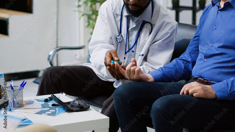 Physician doing insulin level measurement with medical instrument to ...