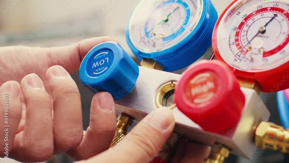 Extreme close up shot of repairman calibrating pressure measurement ...