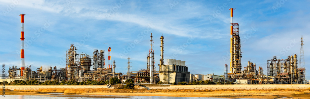 The petrochemical complex at Yokkaichi Port with blue sky background ...