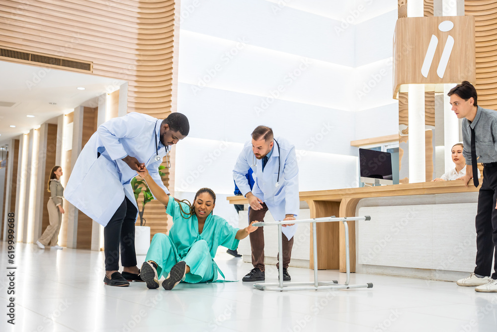 Group of people help female patient falling on the ground in hospital ...
