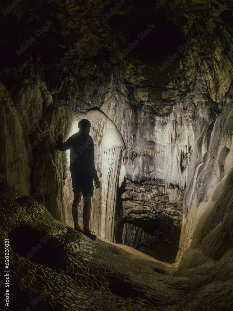 Man exploring the mysterious and natural beauty of Spar Cave on the ...