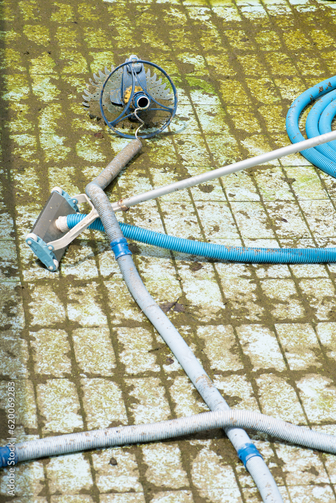 detail of pool robot vacuuming dirt from the floor of an empty and ...