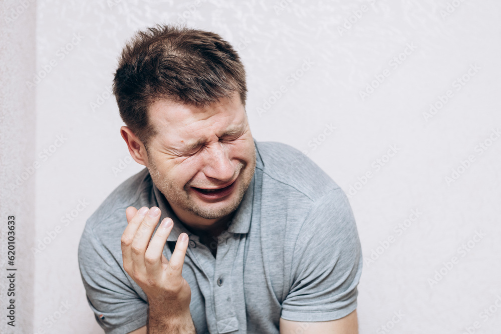 Domestic violence from wife. hysterical man crying. Stock Photo | Adobe Stock
