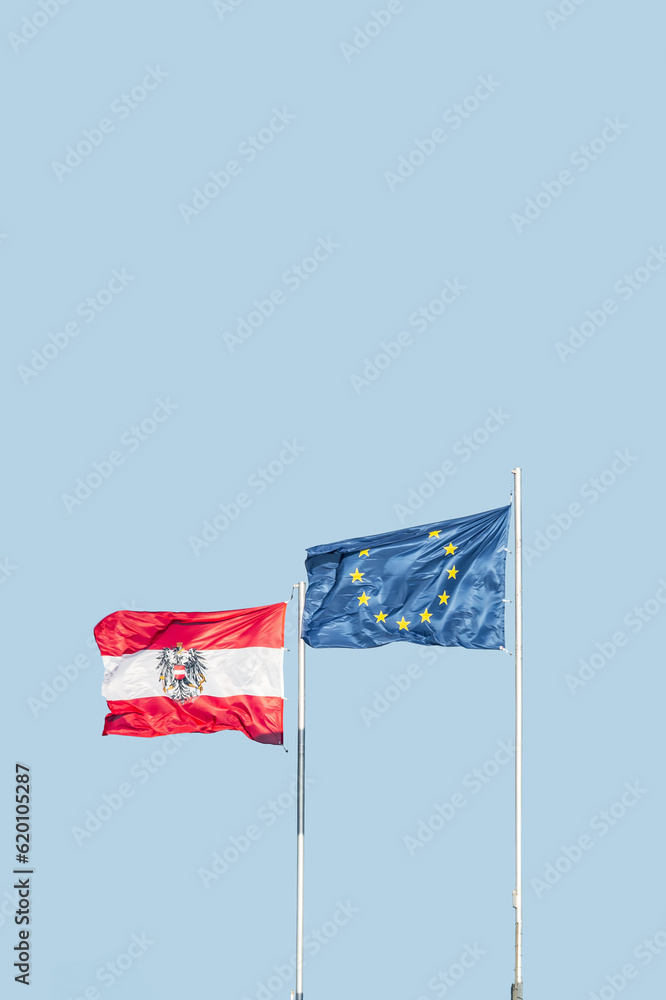 Cover page with two flags of EU and Austria standing in wind together ...