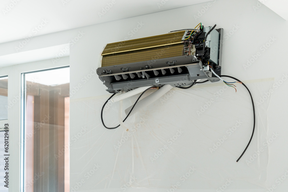 Installation air conditioning system on white wall in apartment, office ...