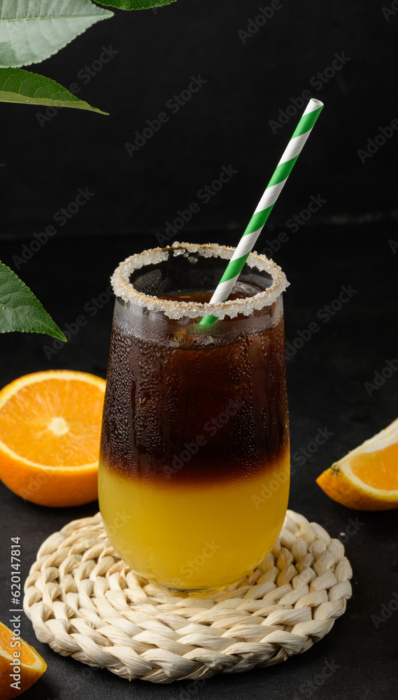 Iced coffee with orange juice in a transparent glass, refreshing bumble ...