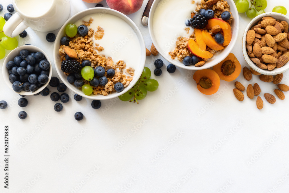 Two healthy breakfast bowl with ingredients granola fruits Greek yogurt ...