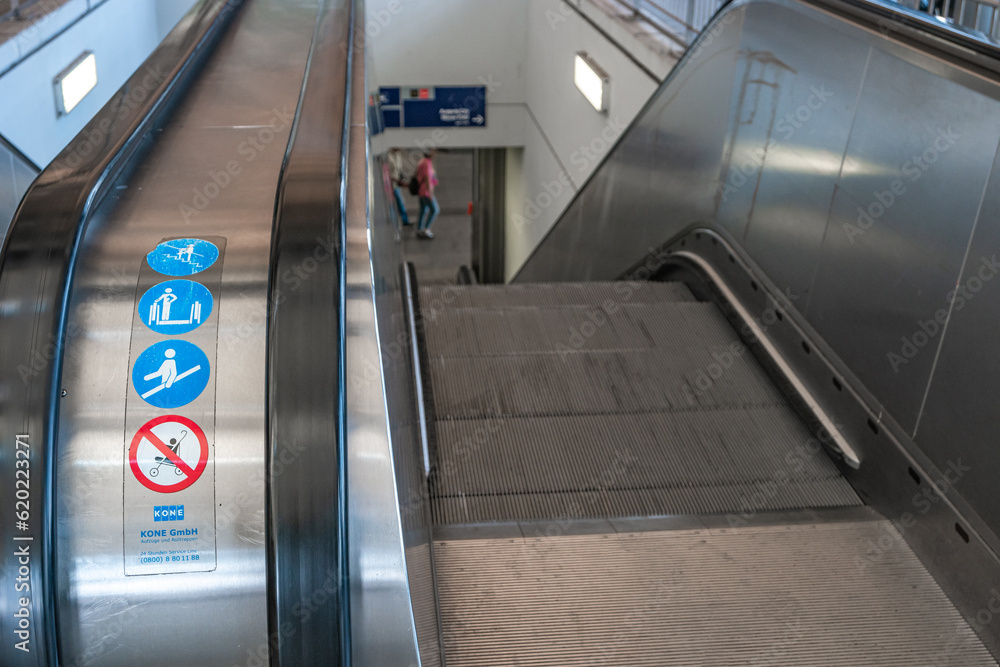 Signs of safety at escalator, moving staircase in central train station ...
