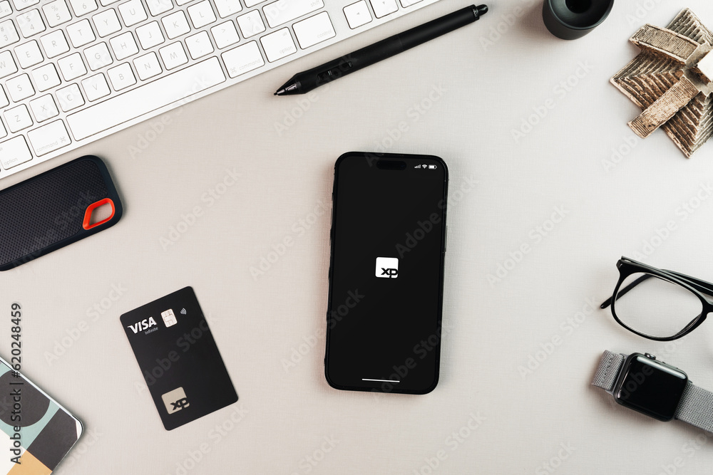 XP Investimentos app on the smartphone iPhone 14 Pro screen on gray ...