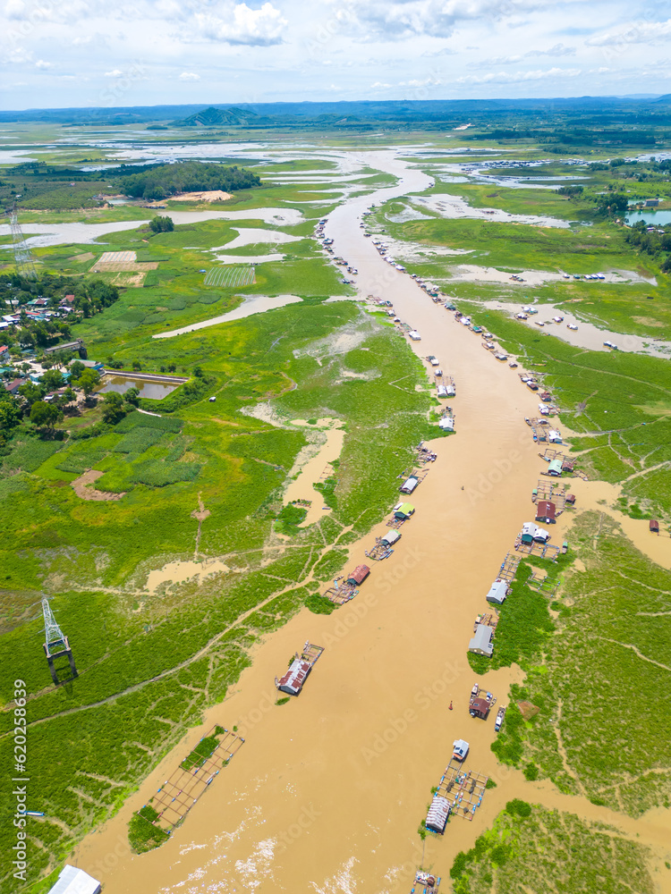 Aerial view of National Route 20 in Dong Nai province, group of floating house on La Nga river ...