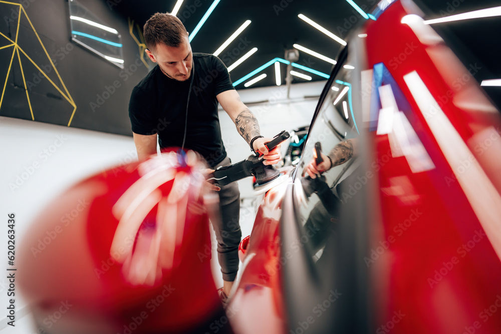 Professional vehicle polishing and detailing service in a modern car ...