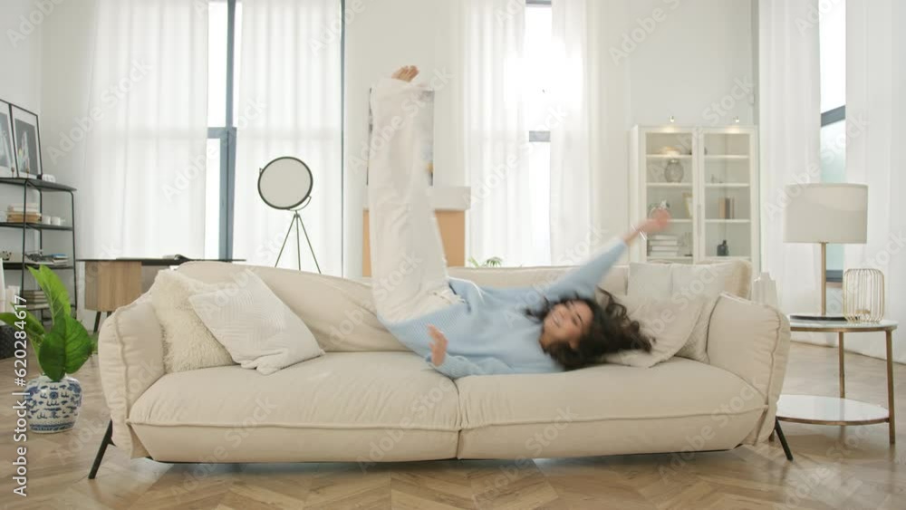 Design interior furniture. Happy Latin American woman jumping on modern ...