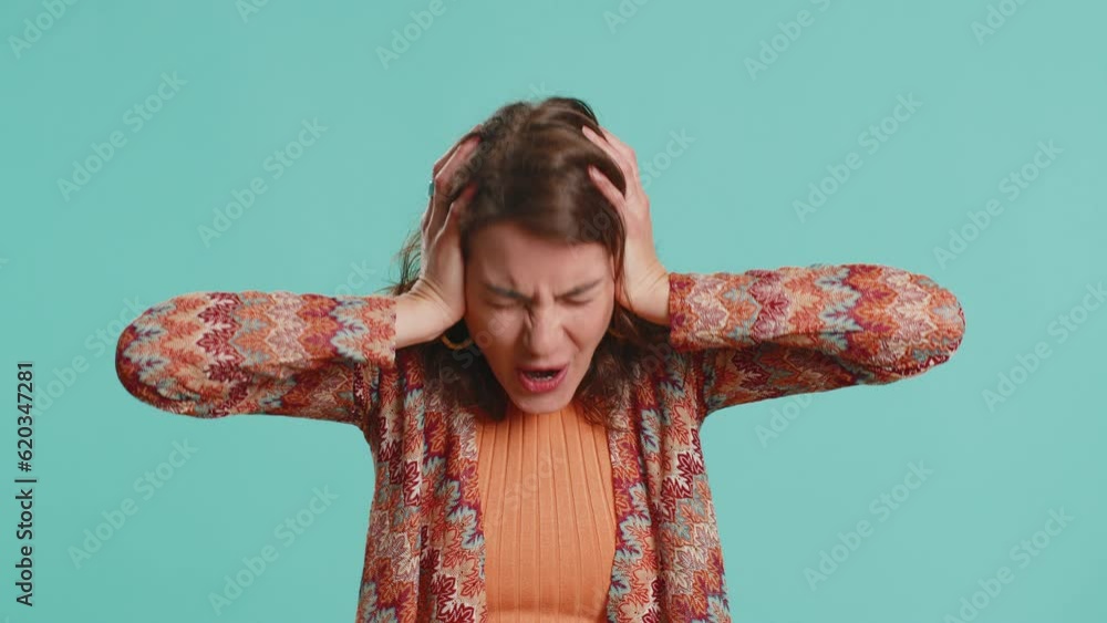 Caucasian woman scared fearful, covering ears with hands, closing eyes ...
