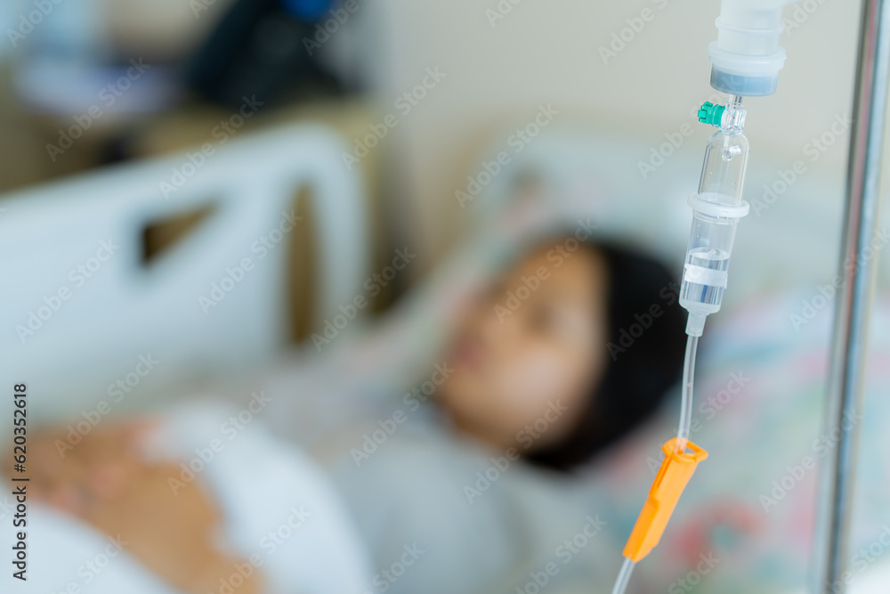 Poster Young patient asian woman lying on the bed in hospital with IV ...
