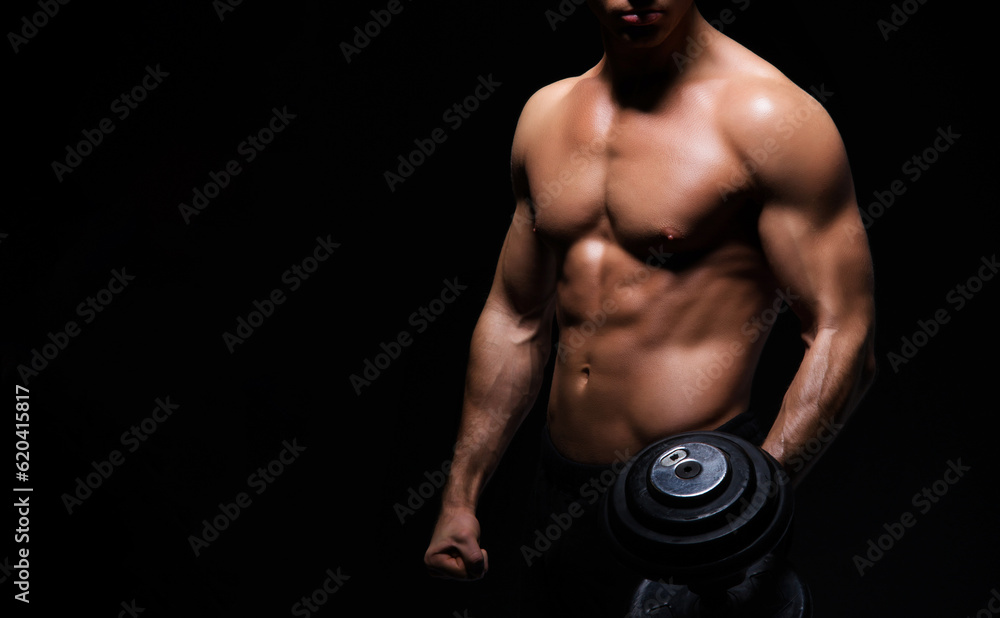 Strong, fit and sporty bodybuilder man with a dumbbell over black ...