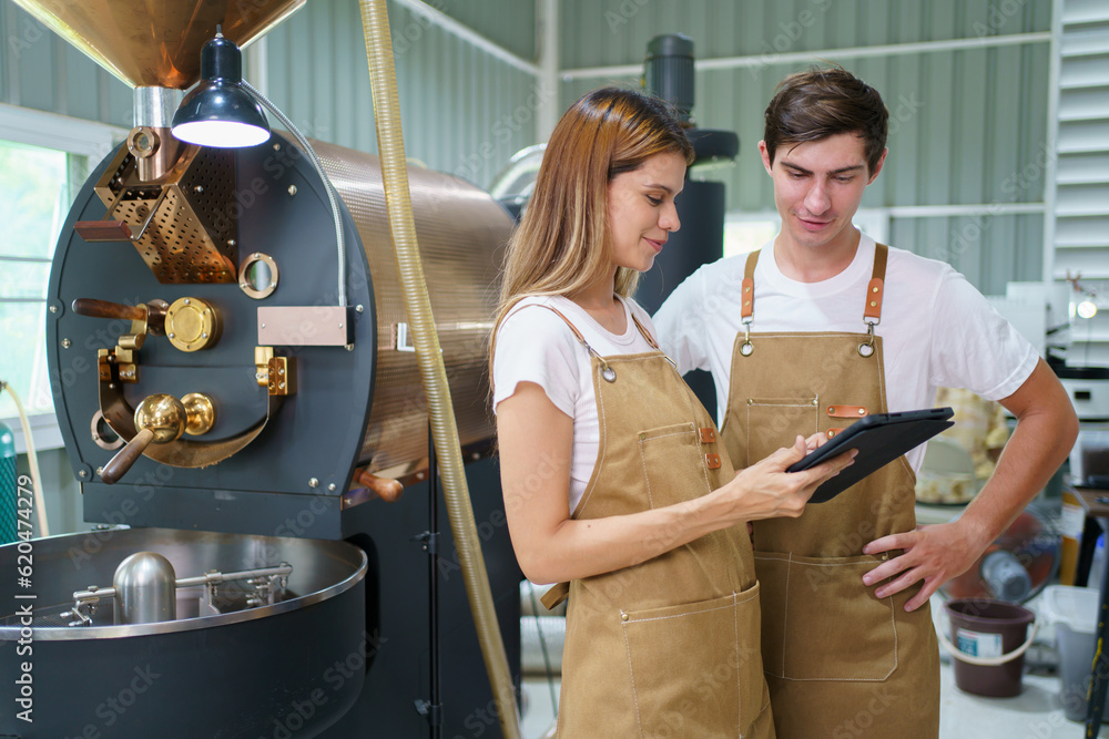 Professional male and female coffee roasters working with modern ...