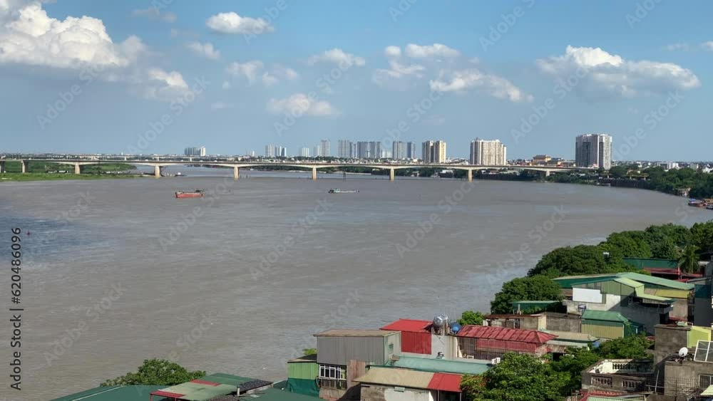 Boats sail through the Red River, also known as Hong river, in Hanoi ...