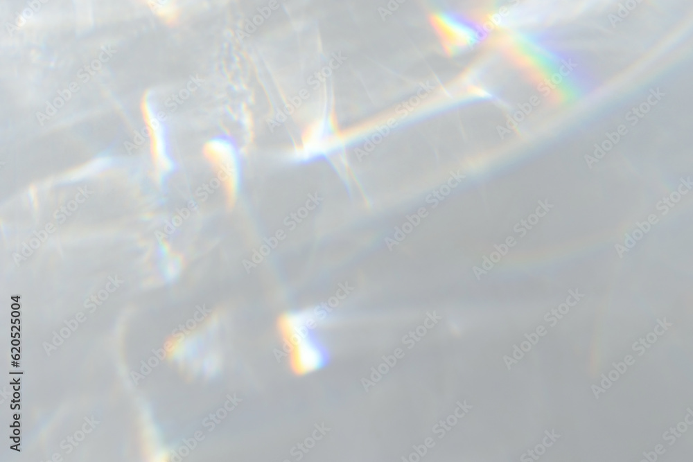 Crystal prism rainbow light refraction texture on white wall background ...