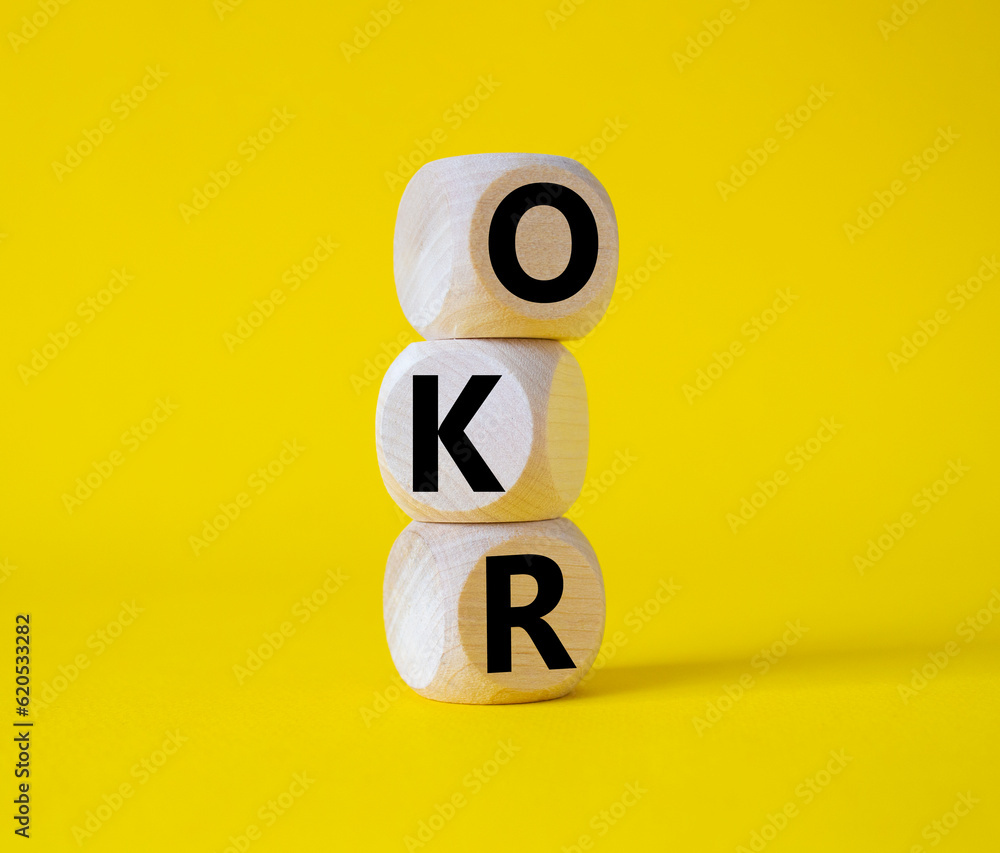 OKR objectives and key results symbol. Wooden cubes with words OKR ...
