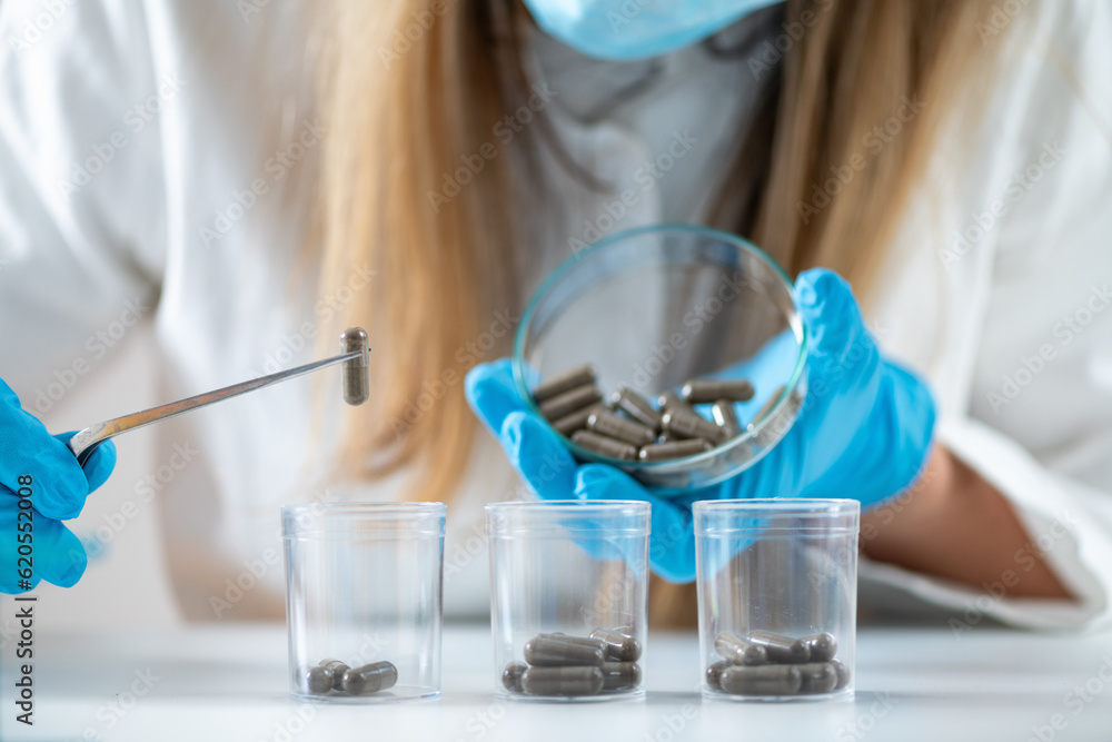 Scientist carefully prepares fecal transplant caps in the lab ...