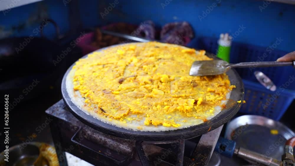 Spreading hot chili and other spices with potato stuff on famous Indian ...