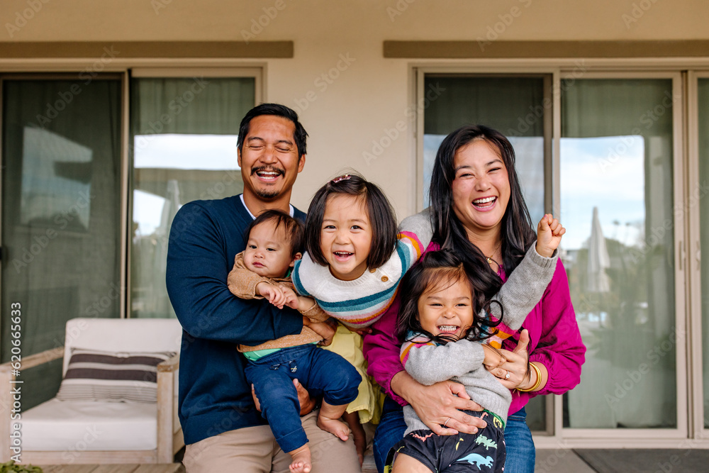 Authentic happy asian family laughing and hugging together Stock Photo ...