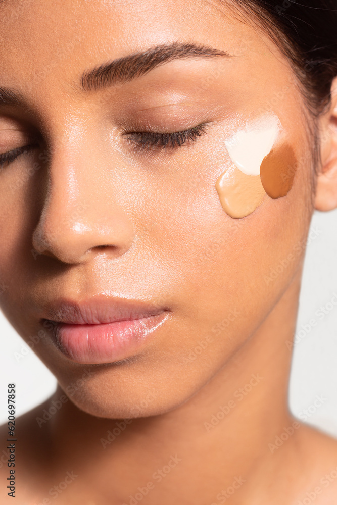 Young model applying different shades of makeup foundation Stock Photo ...