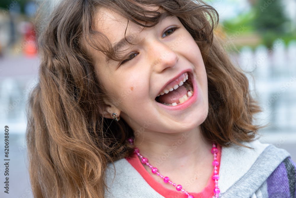 Toothless happy smile of a girl with a fallen lower milk tooth close-up ...
