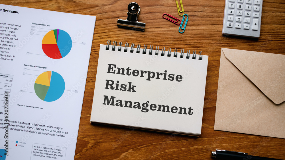There is notebook with the word Enterprise Risk Management. It is an ...