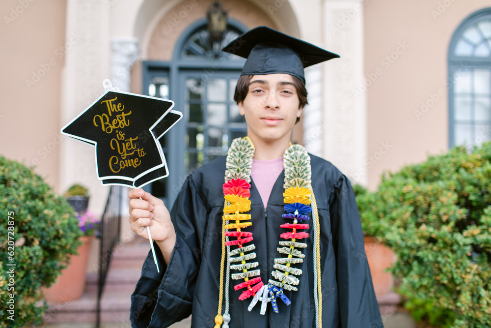 Teen boy with banner on his graduation day Stock Photo | Adobe Stock