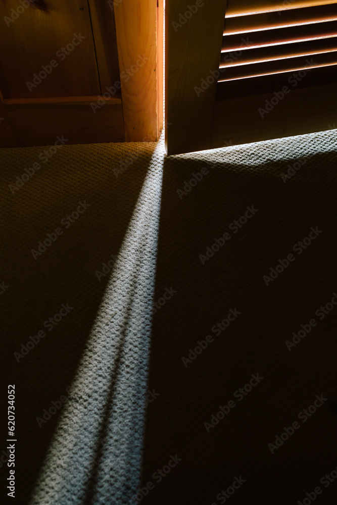 Shaft of Light shining through crack in door in home background Stock ...