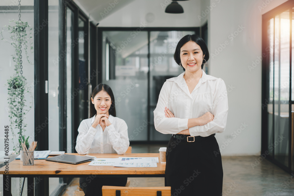 Happy business woman standing competently and smiling in open plan ...