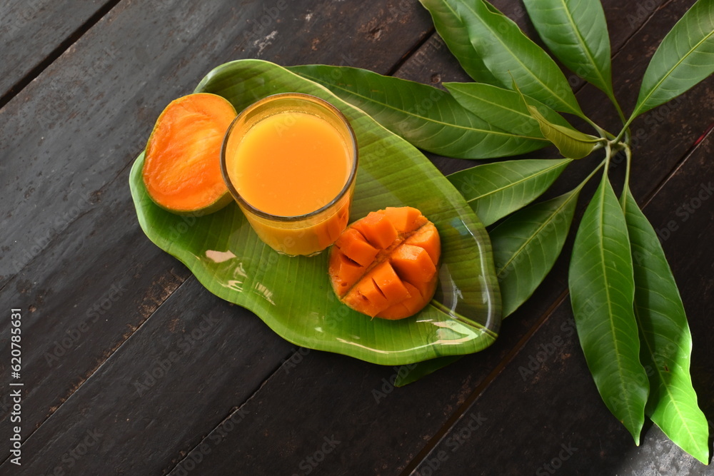 Mango juice with mango slice isolated on black background. Mango shake ...