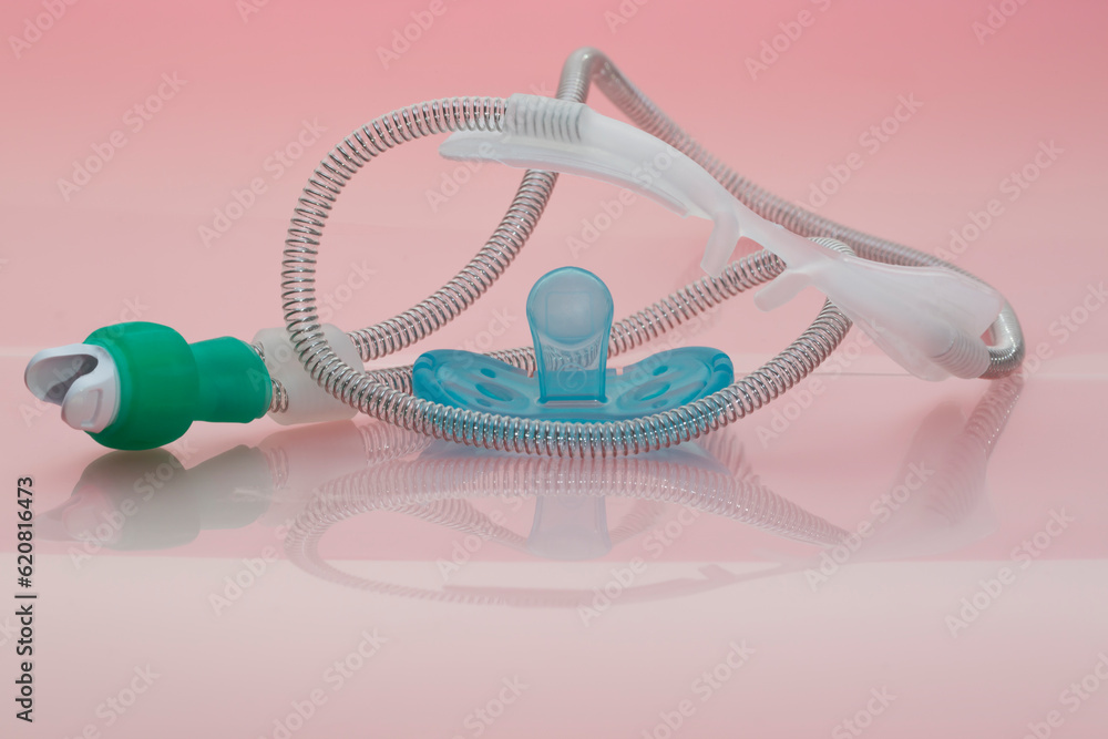 Concept of sick baby. Light blue dummy and nasal oxygen cannula for ...