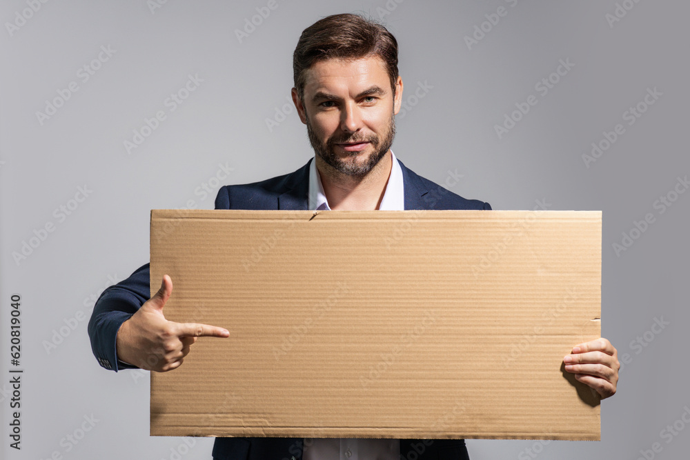 Handsome middle aged man with blank placard. Demonstrating copy space ...