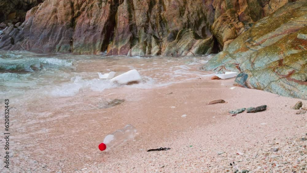 Terrifying dreary picture of littered tropical beach. Waves wash over ...