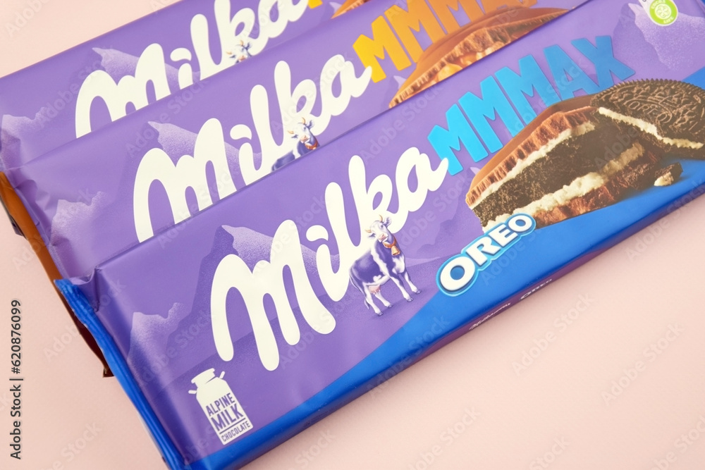 Chocolate brand Milka with Oreo flavor and caramel on a soft pink ...