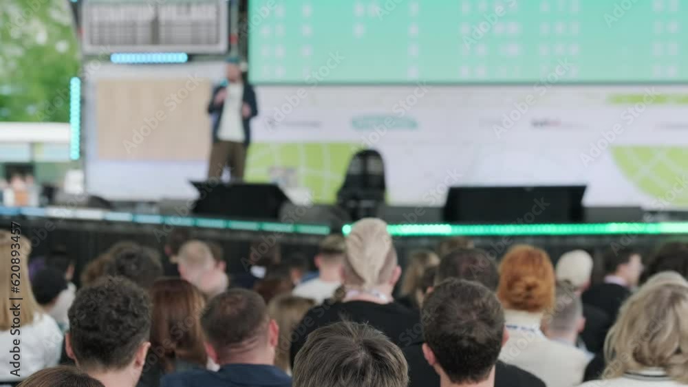 Male coach speaking on stage in front of crowd Stock Video | Adobe Stock