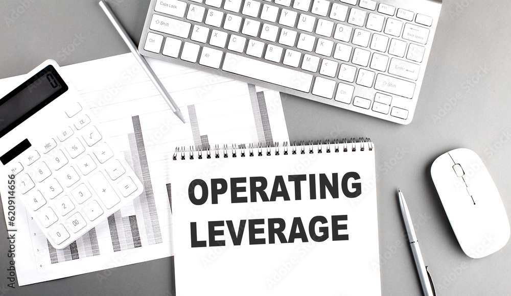 OPERATING LEVERAGE text written on notebook on grey background with ...