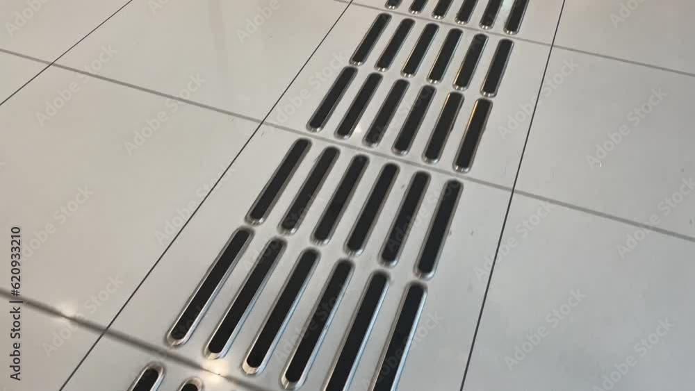 Blind pedestrian walking and detecting markings on tactile paving with ...