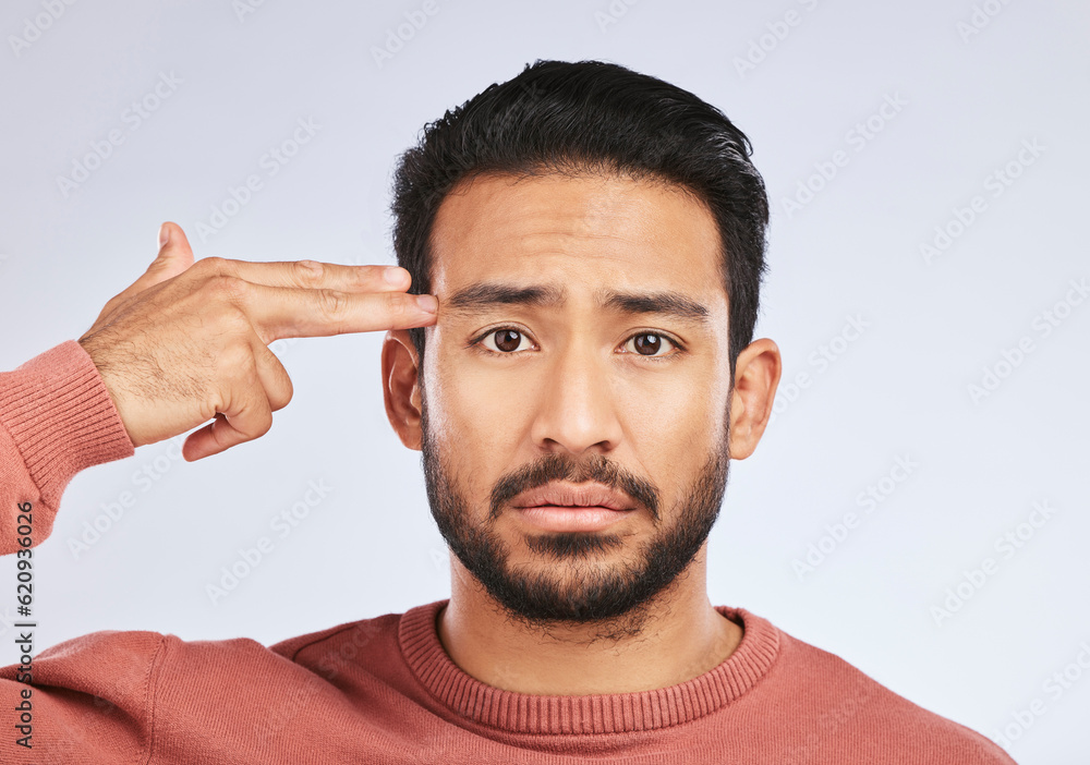 Depression, portrait and sad asian man with hand gun in studio for ...
