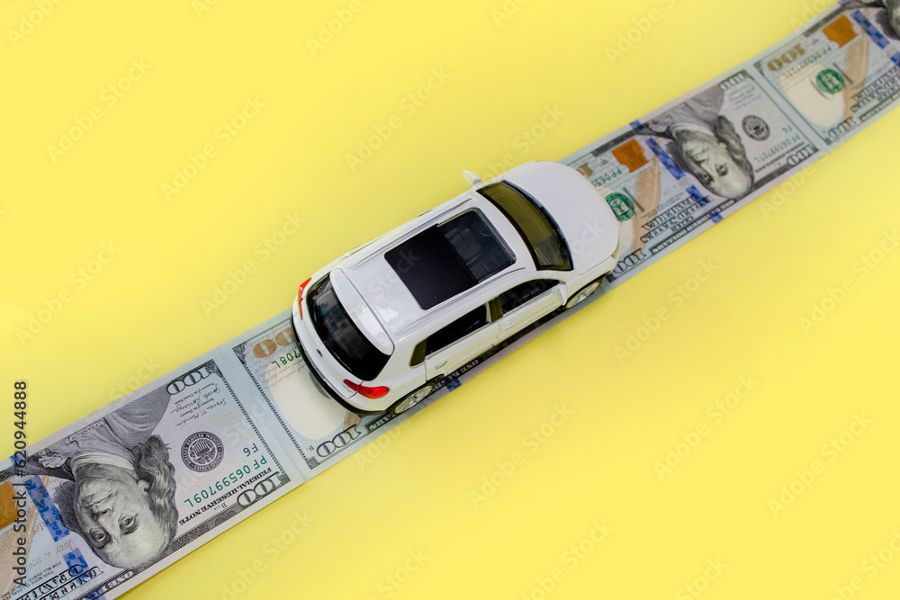 White toy car on money road on yellow background with copy space Stock ...